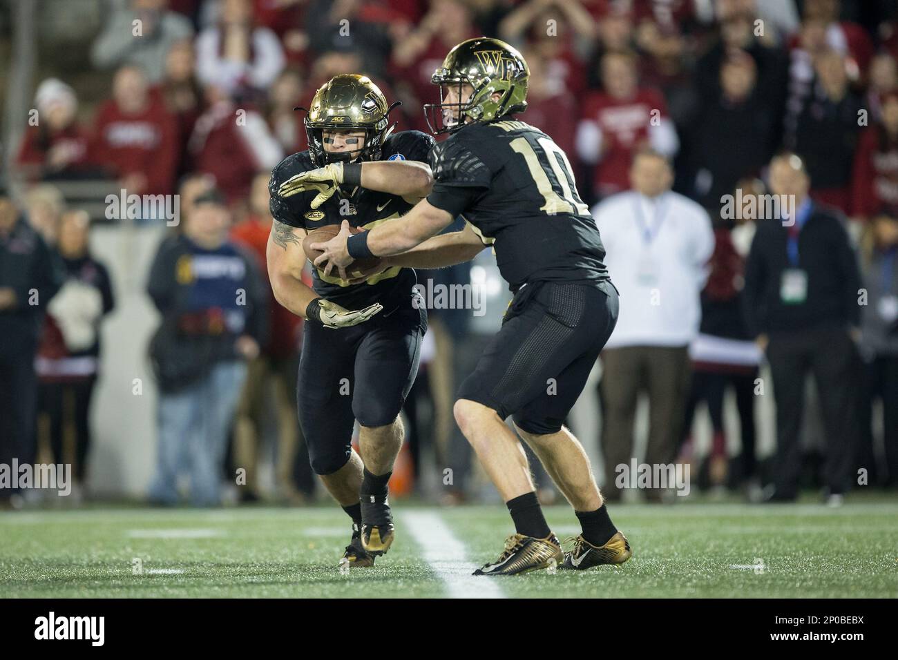 Cade Carney (36) of the Wake Forest Demon Deacons takes a hand off from ...