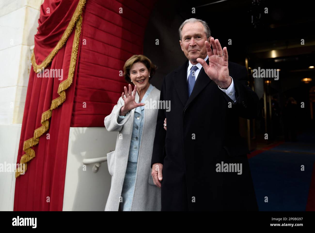 Former President George W. Bush and his wife Laura Bush wave as they ...