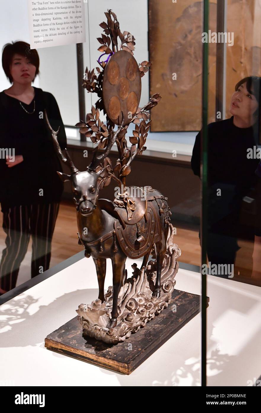 Visitors look at “True Form of the Kasuga Sacred Deer,” a designated ...