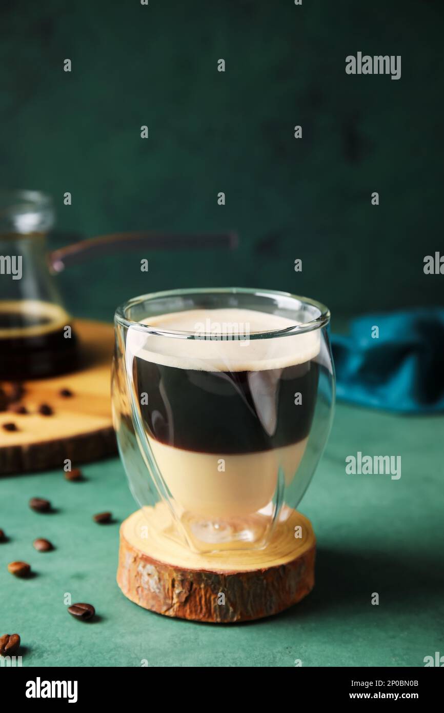Glass of tasty Cafe Bombon on color background Stock Photo - Alamy