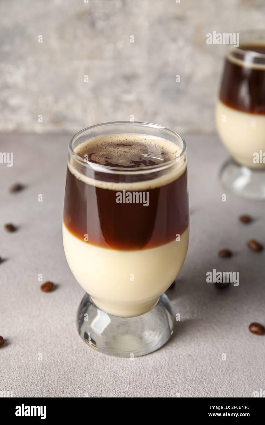 Glass of tasty Cafe Bombon on light table Stock Photo - Alamy