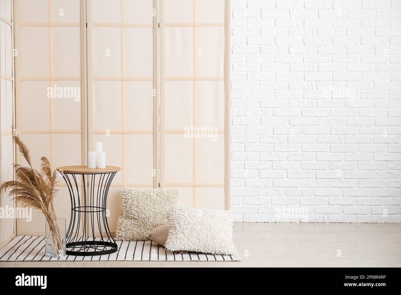 Interior of cozy living room with folding screen and table Stock Photo ...