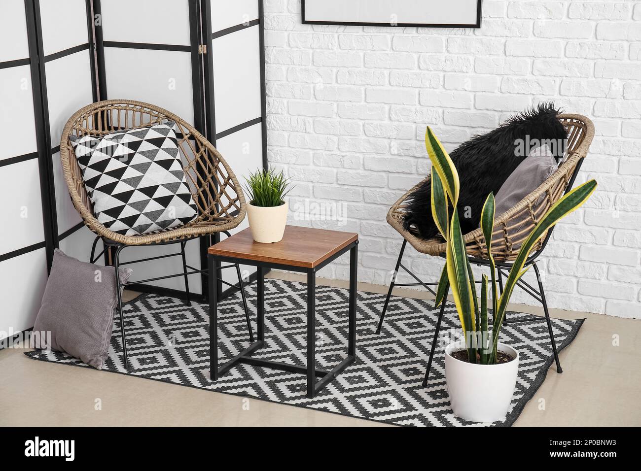 Interior of cozy living room with folding screen, chairs and table ...