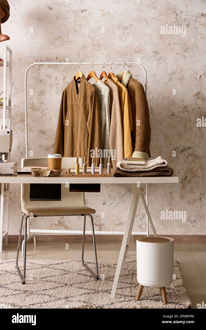 Interior of atelier with workplace and clothes Stock Photo - Alamy