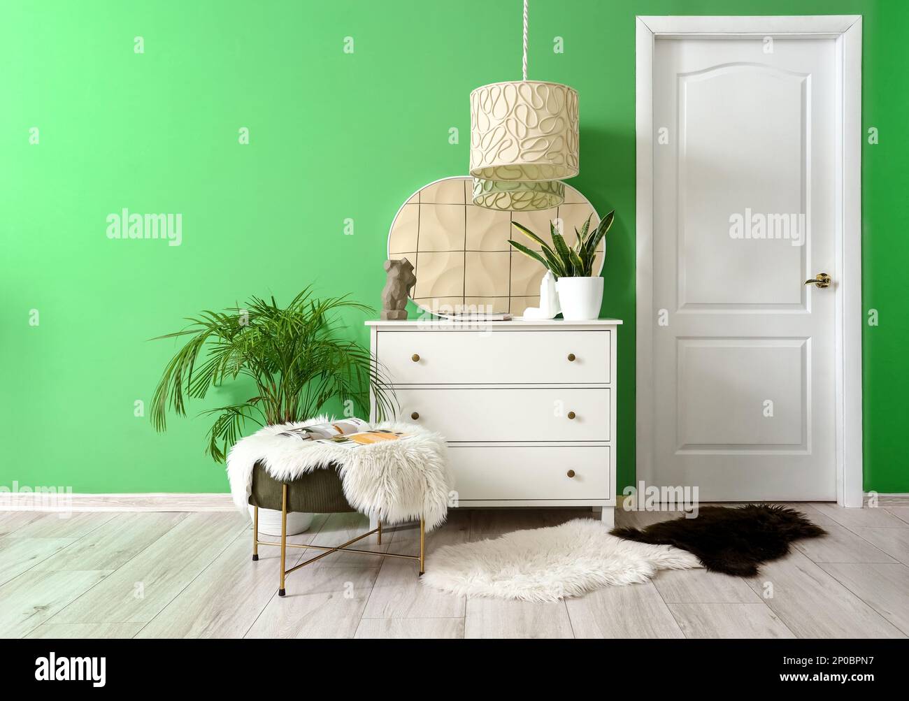 Interior of stylish hall with commode and pouf Stock Photo - Alamy