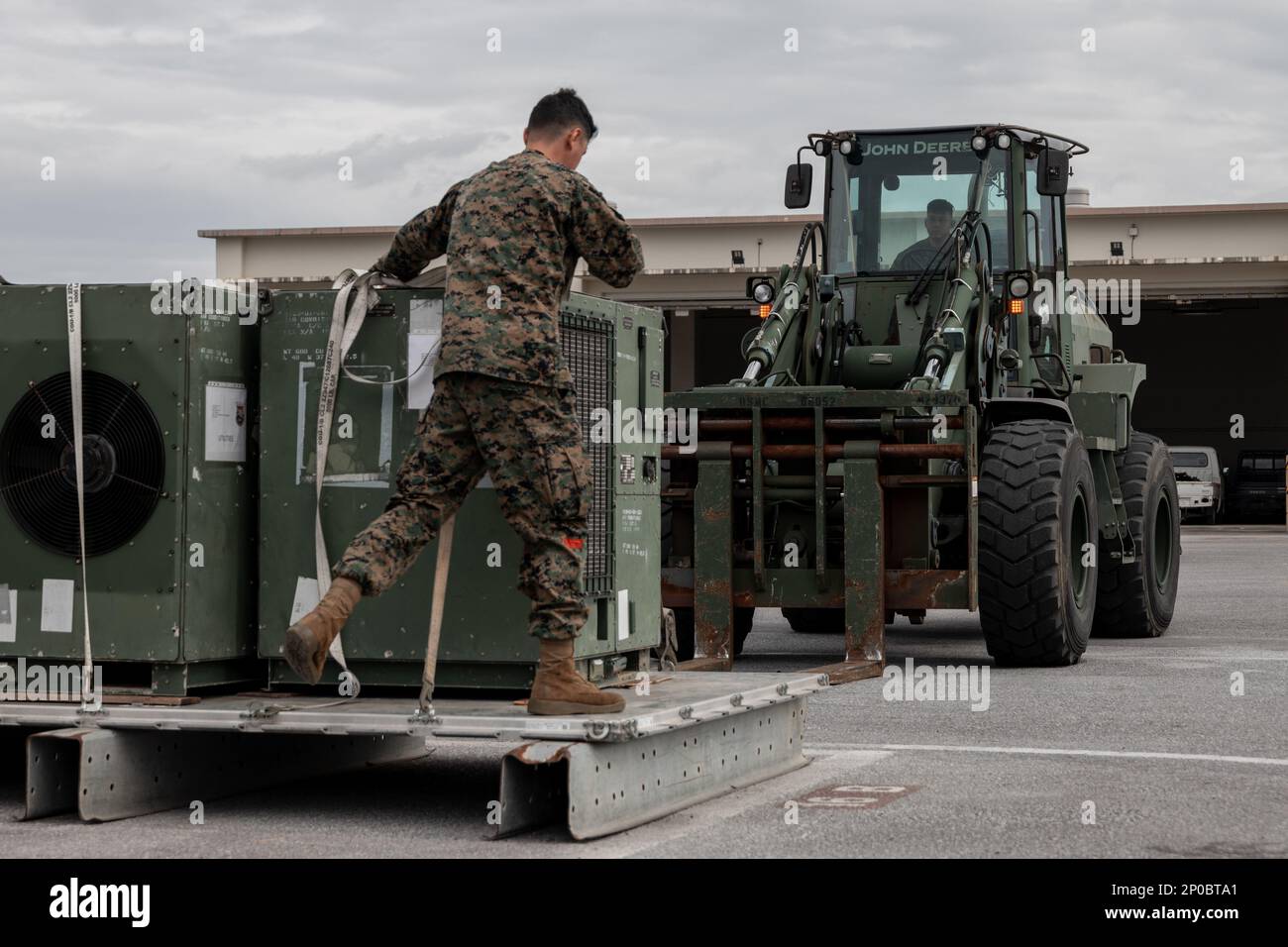 U.S. Marines with 3rd Landing Support Battalion use a tractor, rubber ...