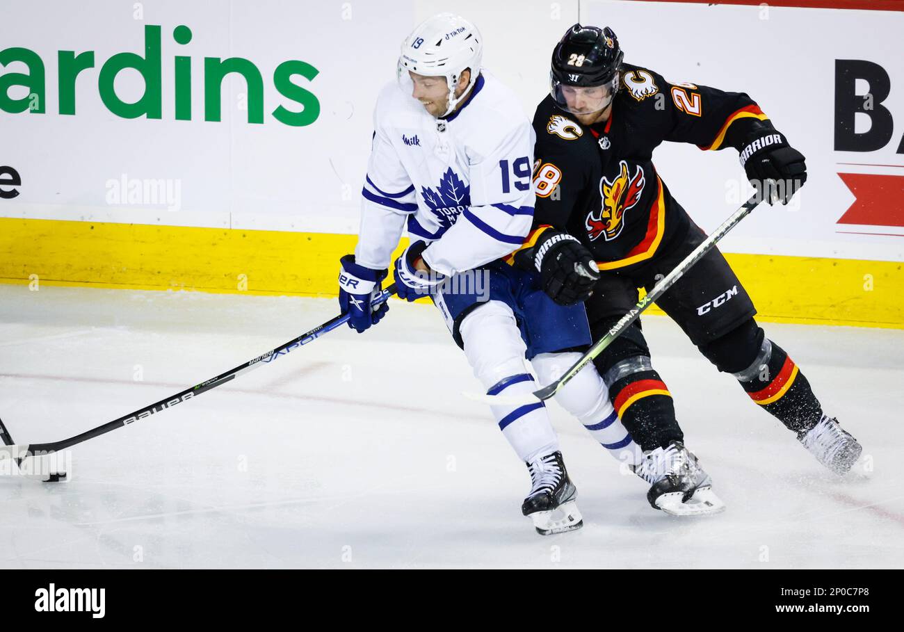 Toronto Maple Leafs forward Calle Jarnkrok, left, is checked by Calgary ...