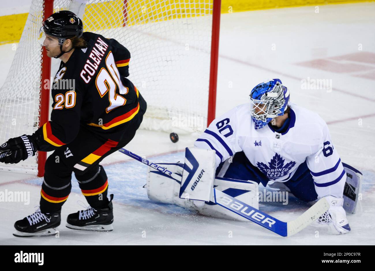Toronto Maple Leafs goalie Joseph Woll, right, looks back as Calgary ...