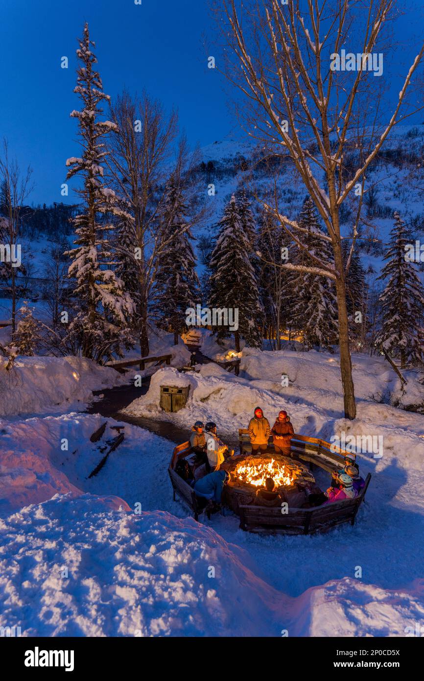 People at night warming up at a gas fire pit at Sundance Resort, also ...