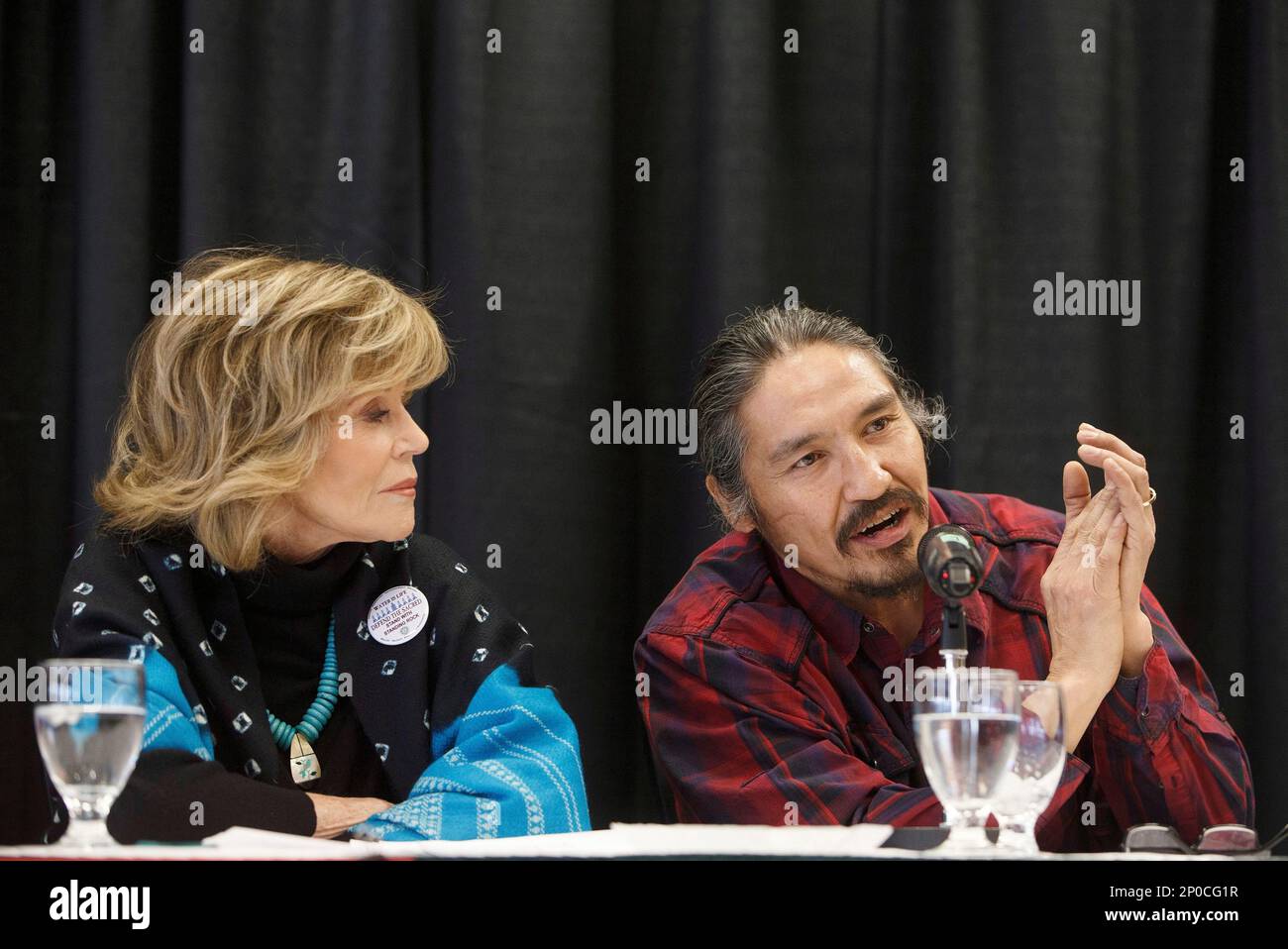 Jane Fonda, left, looks on as Athabasca Chipewyan First Nation Chief ...
