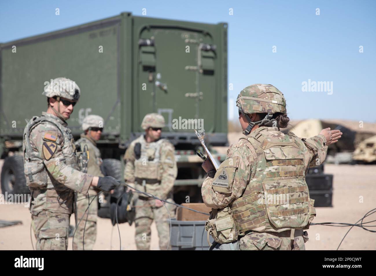 1st Armored Division Soldiers take instructions from a leader during ...