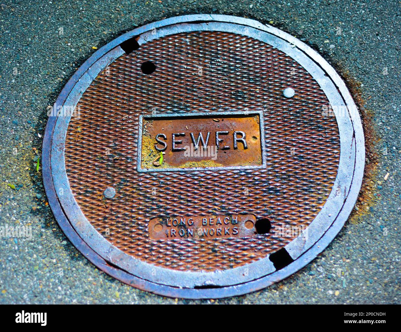 Colorful utility manhole cover convey an aging industrial era, made of ...