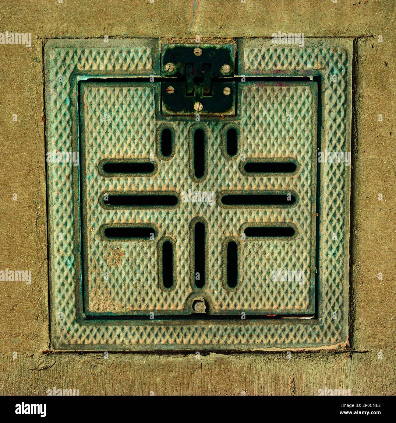 Colorful utility manhole cover convey an aging industrial era, made of ...