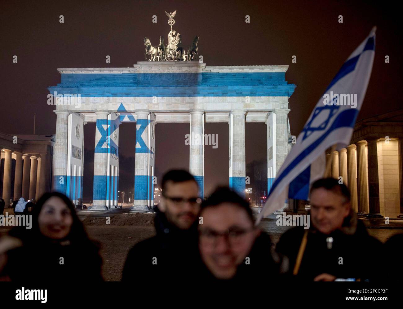 The Brandenburg Gate is illuminated in the colours of the Israeli flag ...
