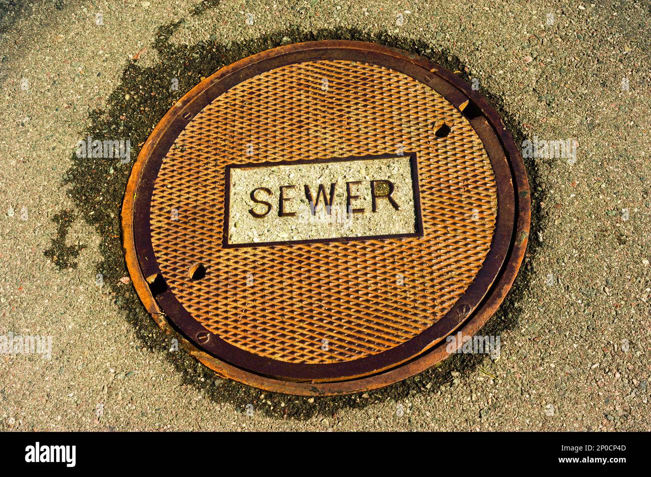 Colorful utility manhole cover convey an aging industrial era, made of ...