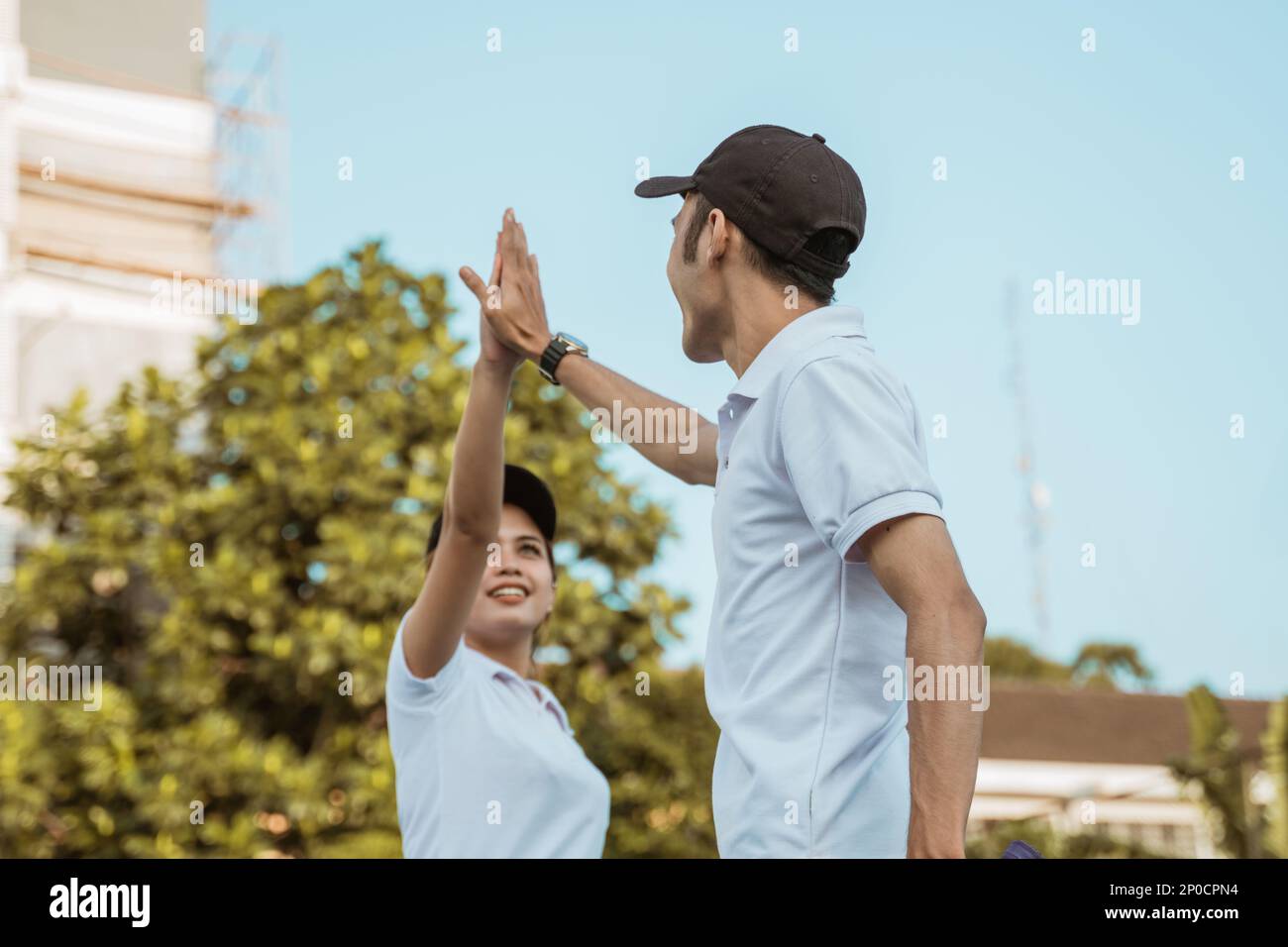 male and female tennis players give each other a high-five Stock Photo ...