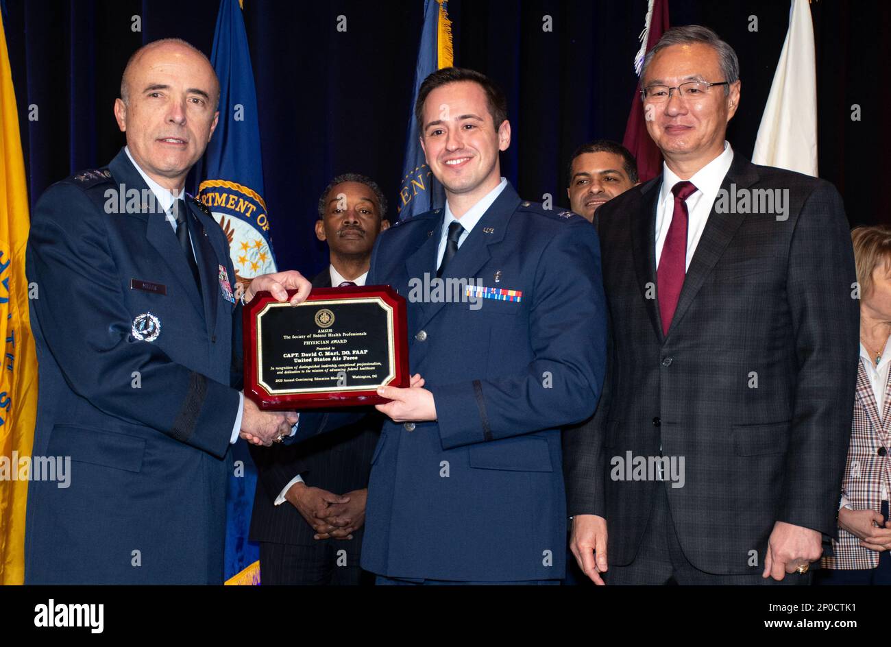 U.S. Air Force Capt. David Mari is presented with the AMSUS Physician ...