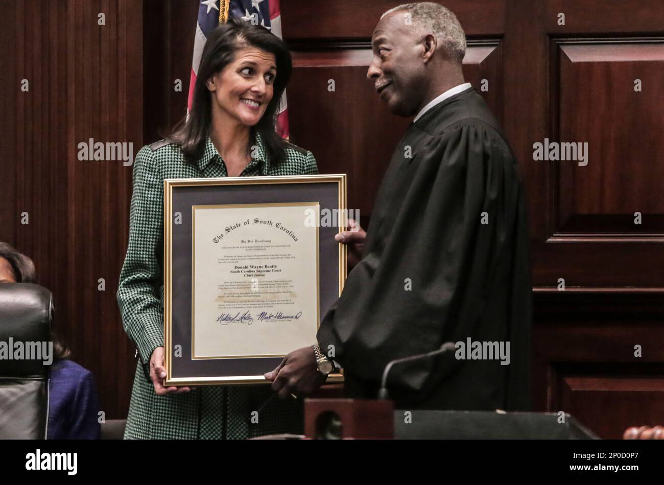 South Carolina Gov. Nikki Haley presents a certificate to Supreme Court ...