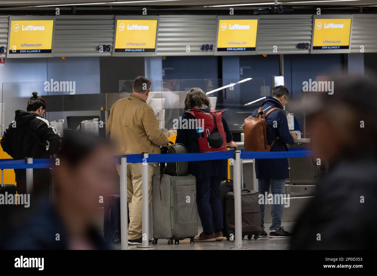 28 February 2023, Hesse, Frankfurt/Main: Passengers stand at the ...