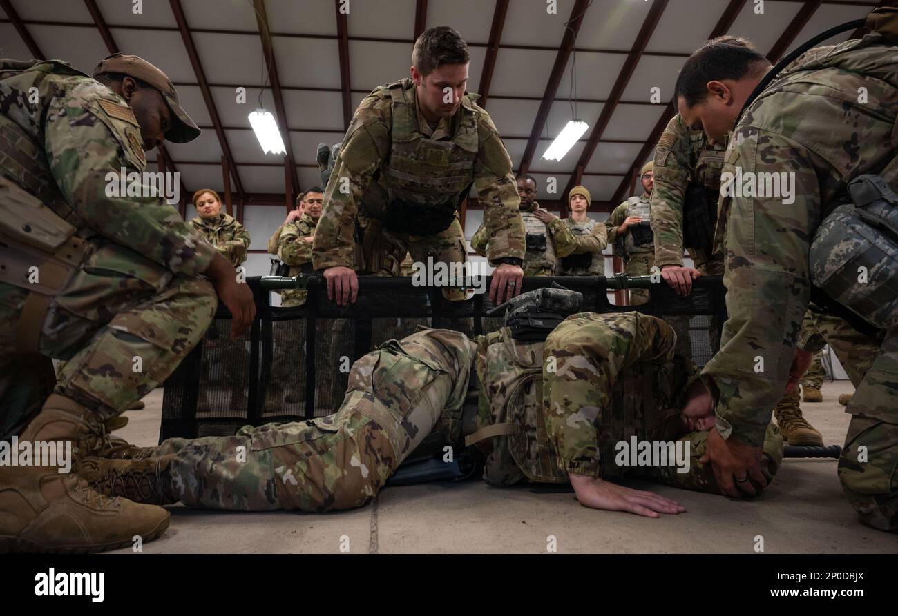U.S. Air Force Airmen prepare to move a simulated patient onto a ...