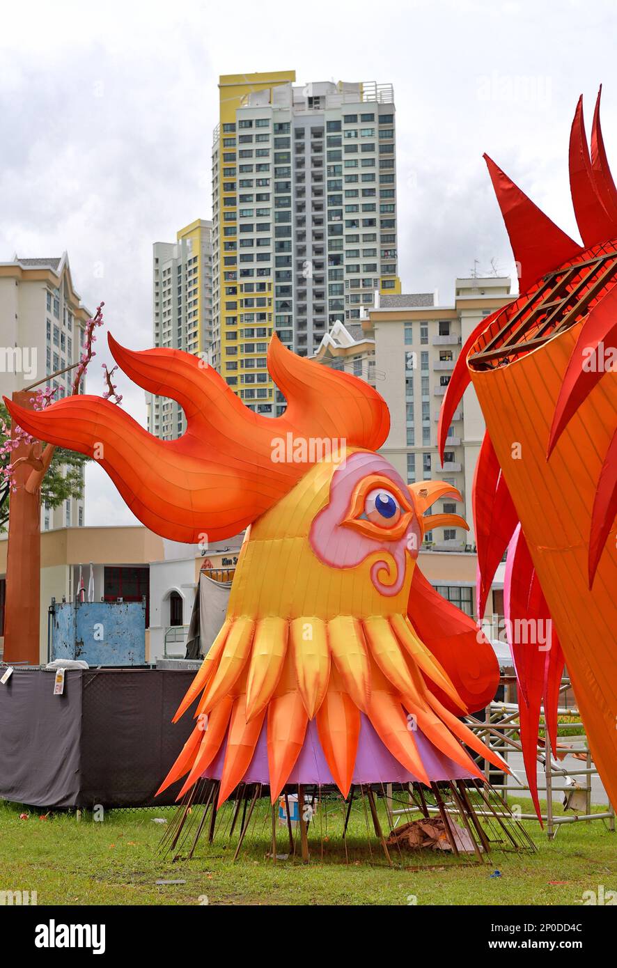 The completed head of the 13-m tall rooster sits on a grass field along ...