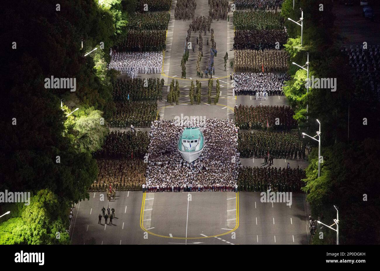 A replica of the Granma yacht is surrounded by soldiers and students ...