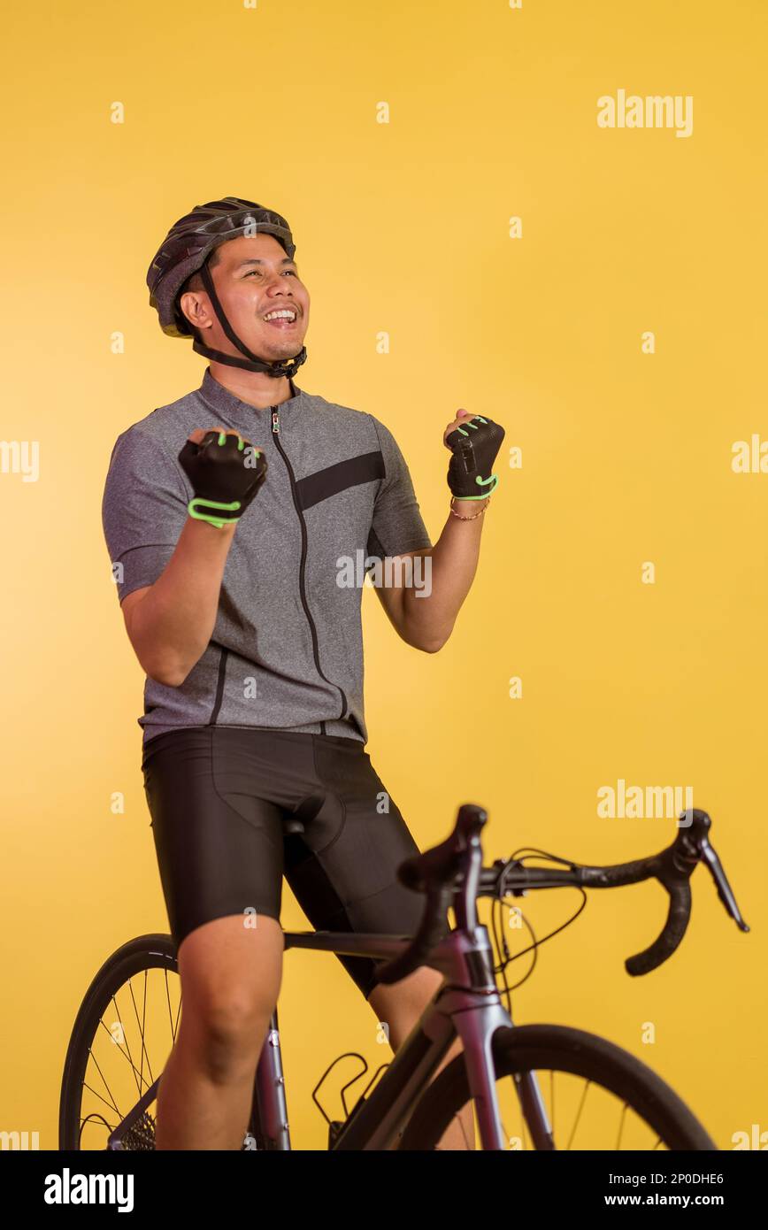 happy asian man sitting on the bicycle with clenched arms Stock Photo ...