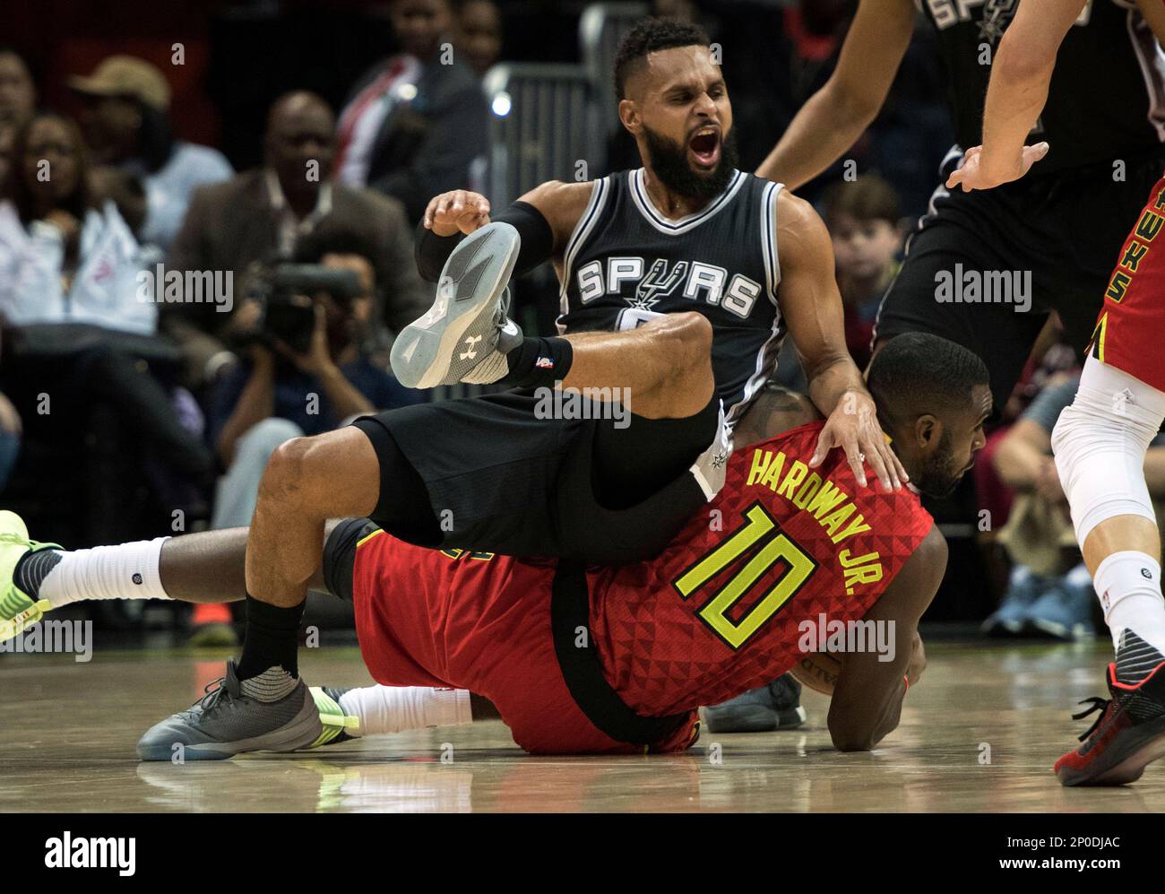 San Antonio Spurs guard Patty Mills, top, of Australia, falls on ...