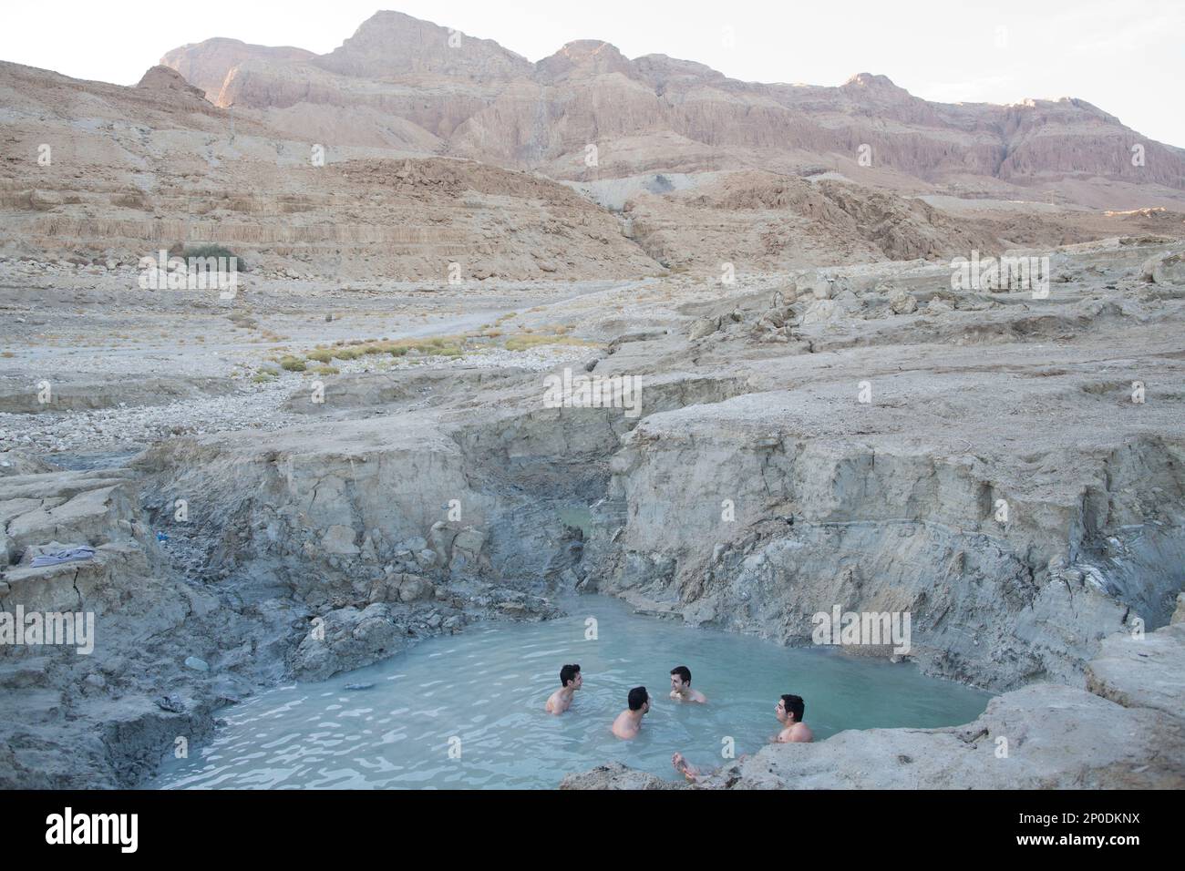 Israelis bath in a hot water spring on the shore of the Dead Sea near ...