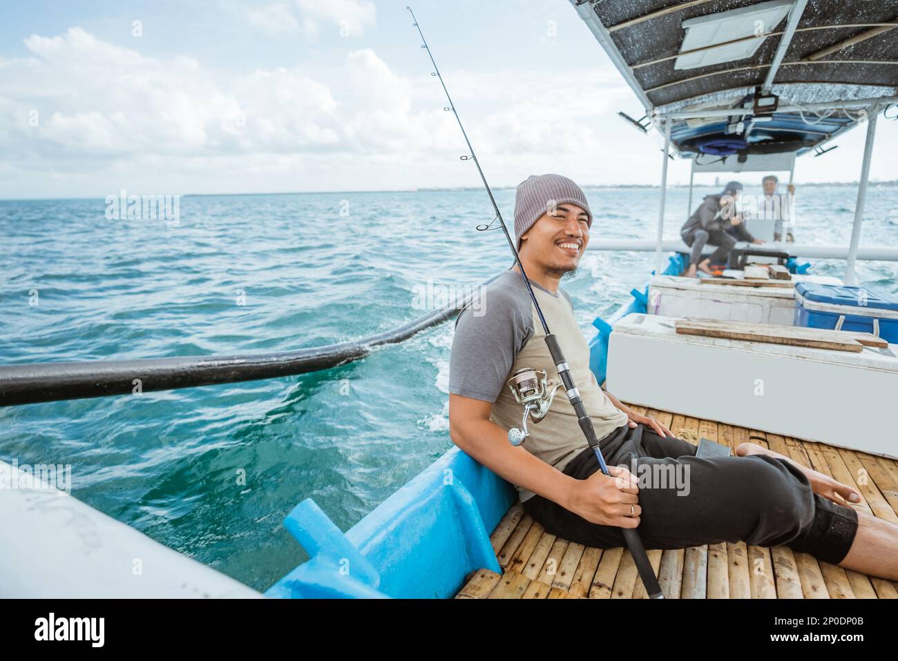 fisherman break fishing sitting on a small fishing boat Stock Photo - Alamy