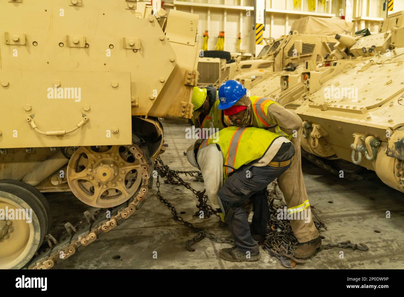 Stevedores chain down a Bradley Fighting Vehicle on the ARC Integrity ...