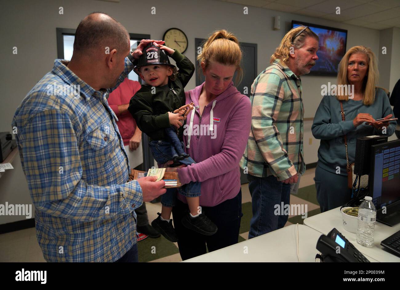 Jason Spade, left, puts a plastic fireman's hat on his son Patrick ...