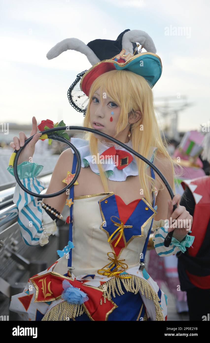 A participant as a cosplayer poses for a photographer during “Comic ...