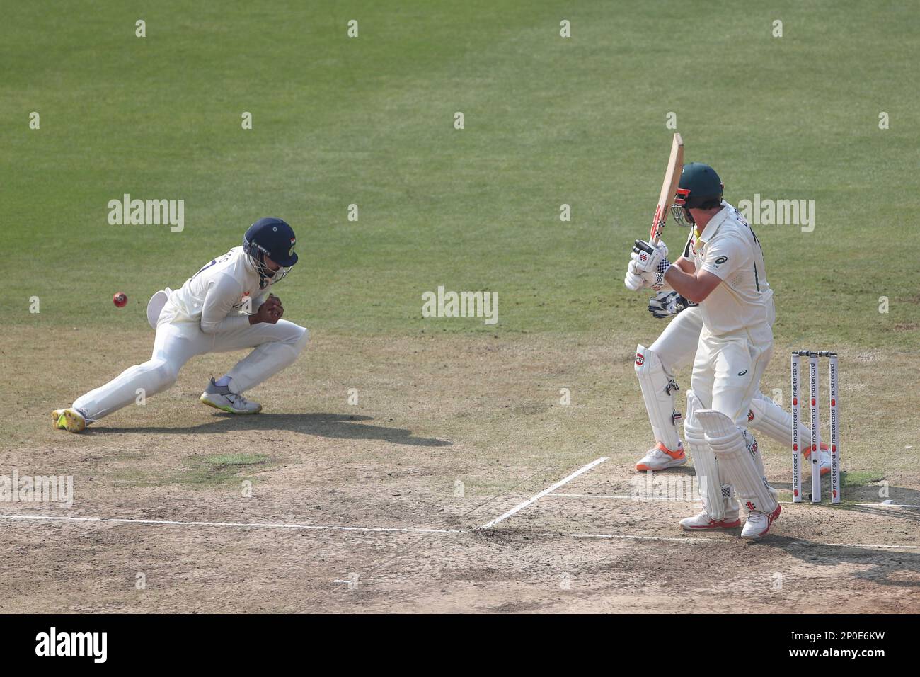 India's Shreyas Iyer, left, reacts to try and catch out Australia's ...