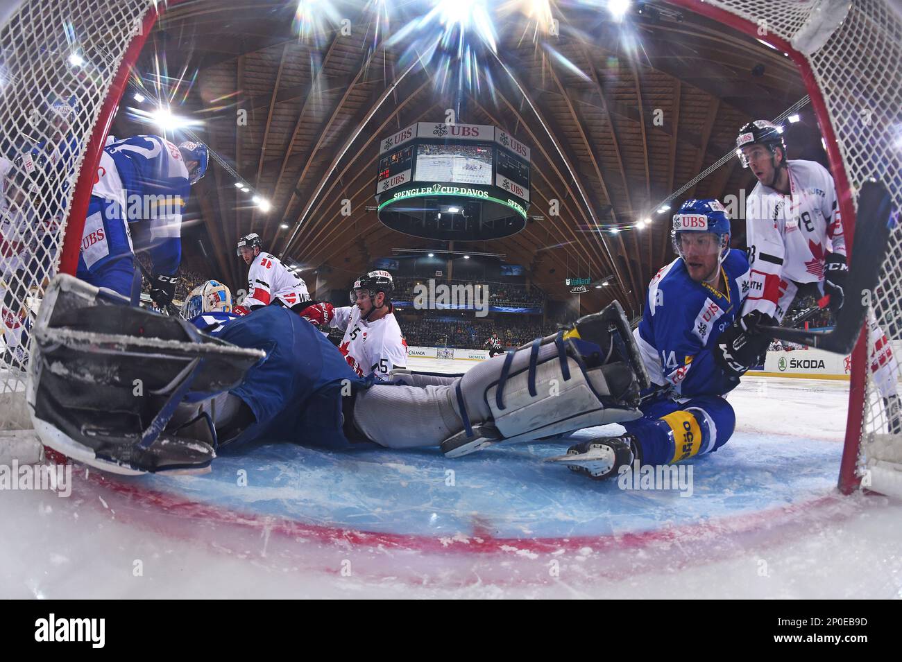 Davos's goalkeeper Gilles Senn, left and Adam Hall defend the goal ...