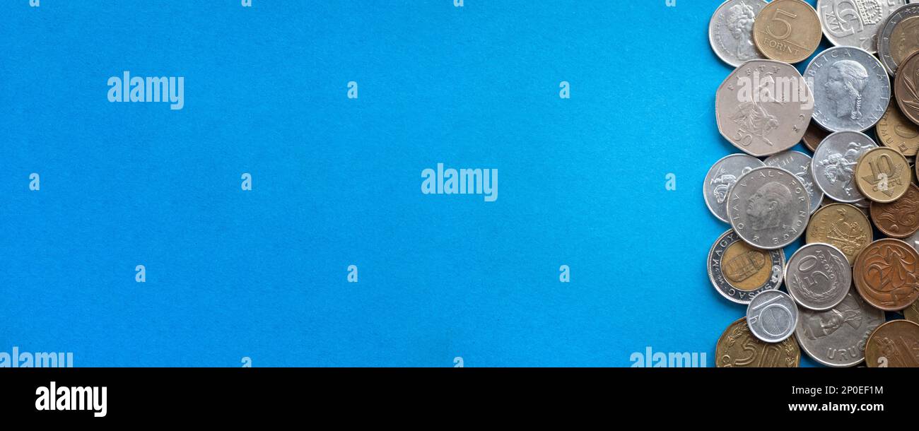 Coins of world's countries on the blue backgrouns, banner ...