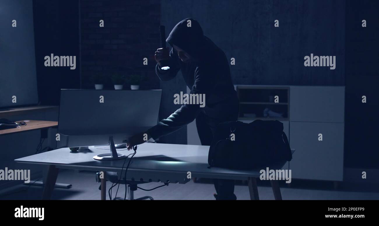 Thief Stealing Computer From Office At Night Stock Photo - Alamy