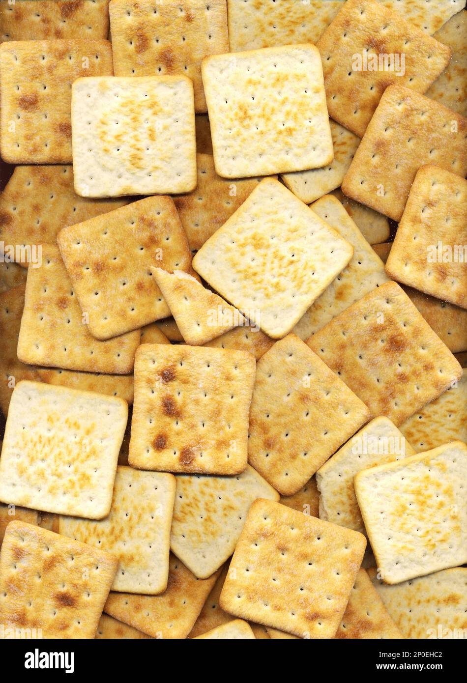 Pile of square salty crackers background. Many baked graham crackers ...