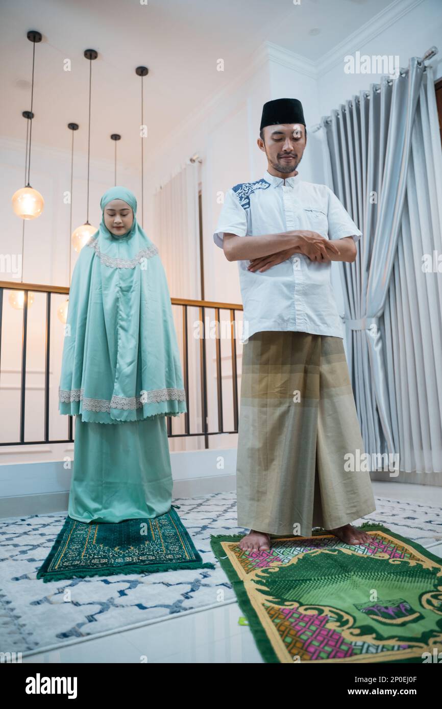 Asian man leads prayer with woman during Surah Al-Fatihah movement ...