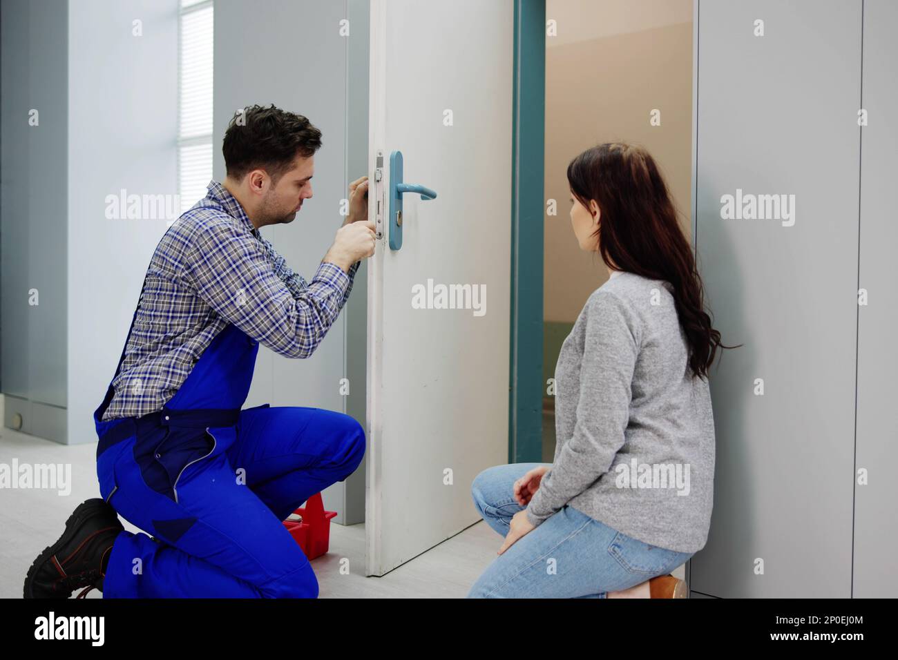 Woman locksmith fixing lock hi-res stock photography and images - Alamy