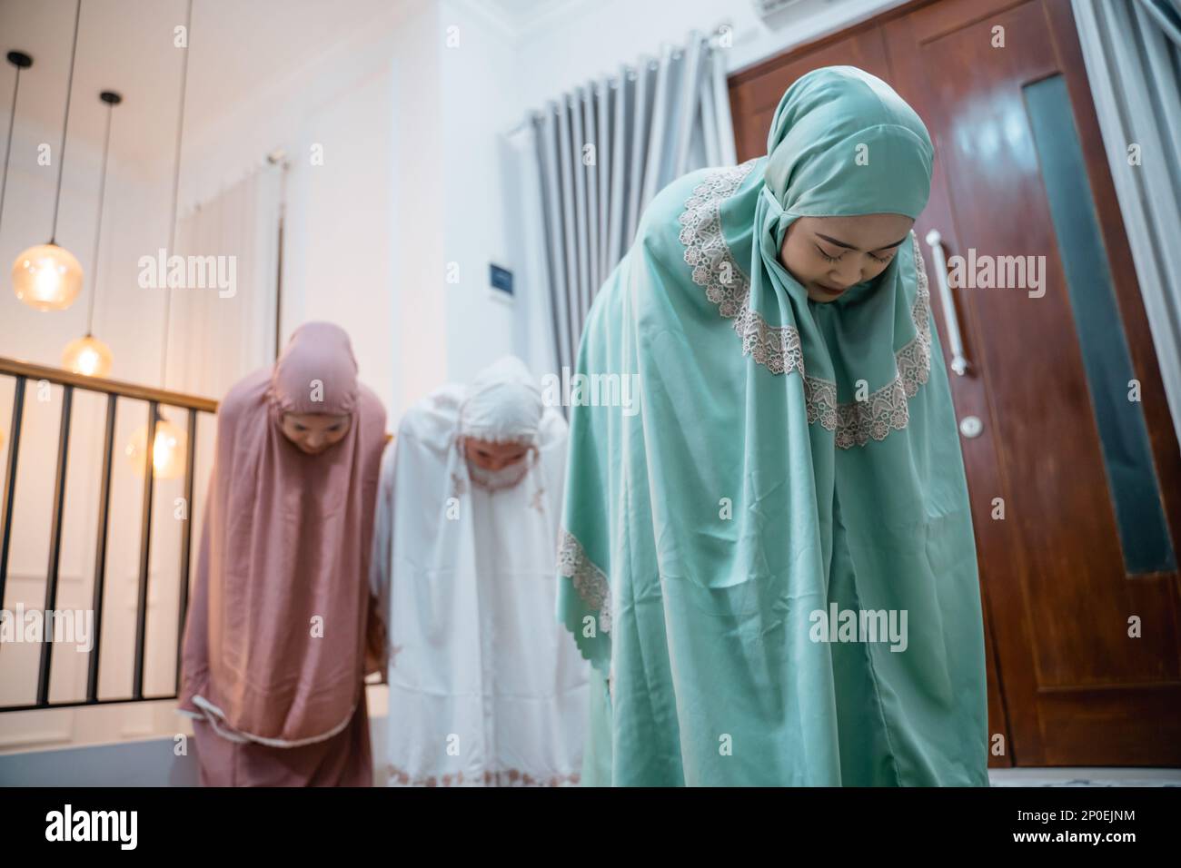 Asian Muslim women in muslim clothes doing ruku prayer movements Stock ...