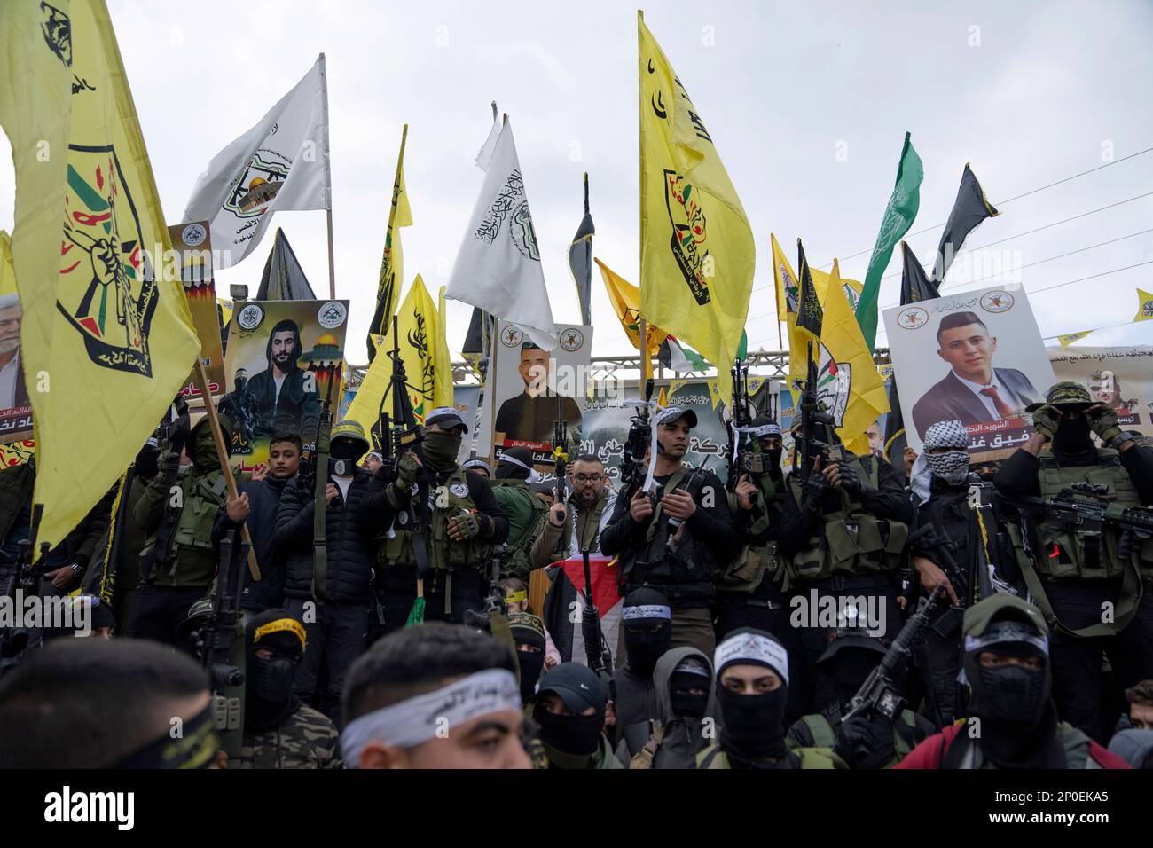 Palestinian militants carry posters with names and pictures of their late comrades Ezzeddin ...