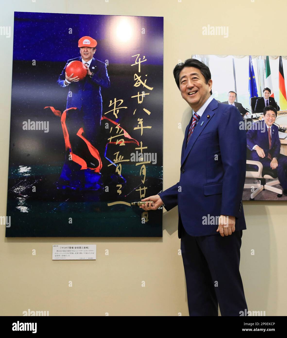 Japanese Prime Minister Shinzo Abe poses after signing an autograph on ...