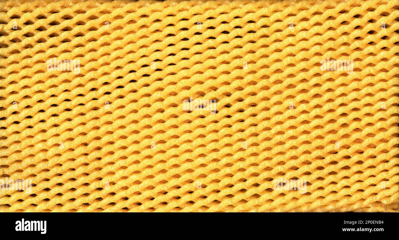 Yellow EPE fruit net abstract close-up background. Expanded ...