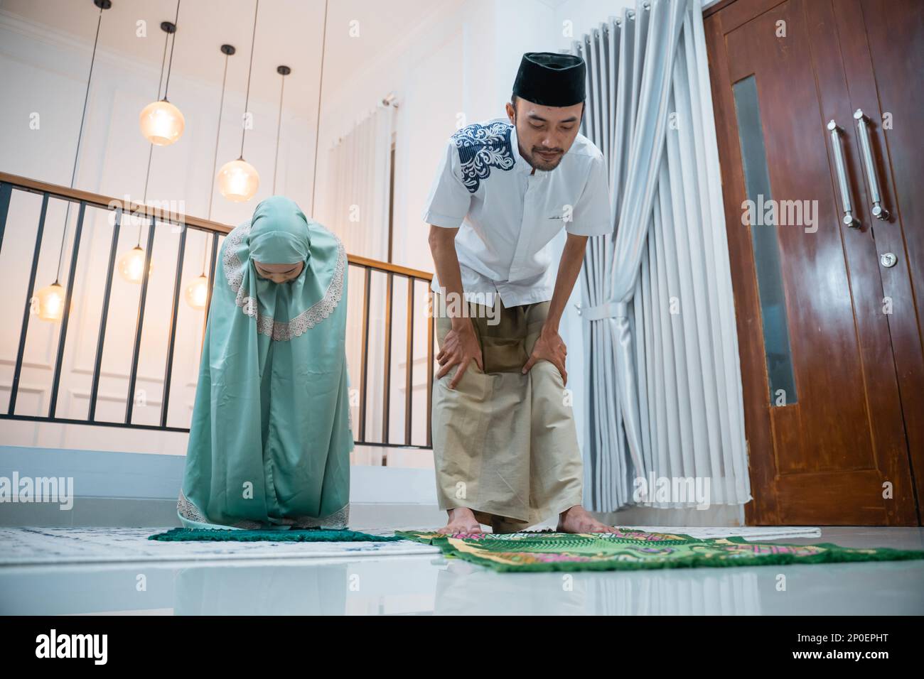 Asian husband leads prayer with wife during Ruku movement Stock Photo ...