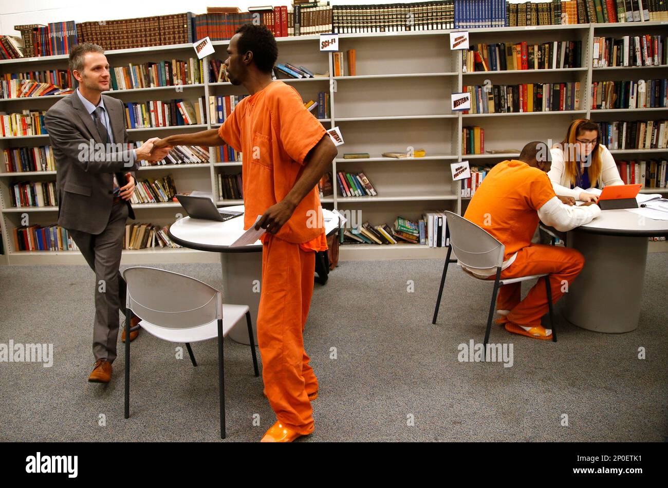 Inmate Jarrod Gilliam (right) shakes hands with Public defender Chase ...