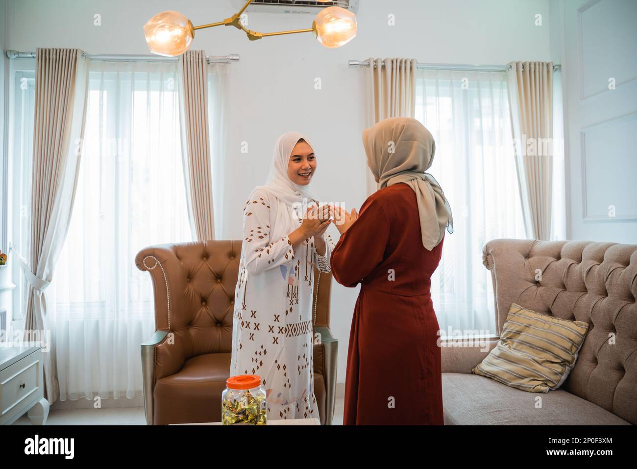 Asian muslim family visiting friend hi-res stock photography and images ...