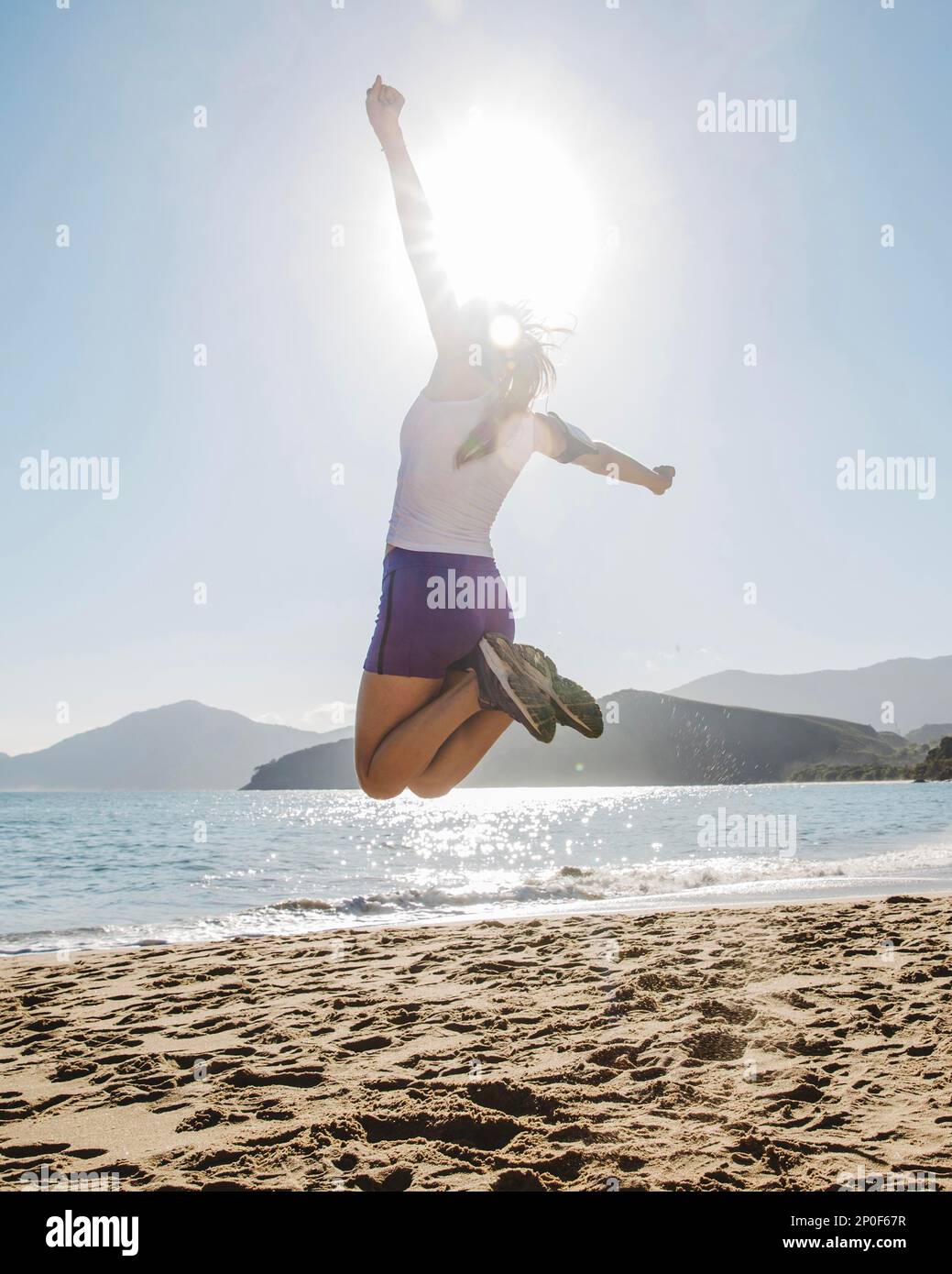 happy young woman jumping Stock Photo - Alamy