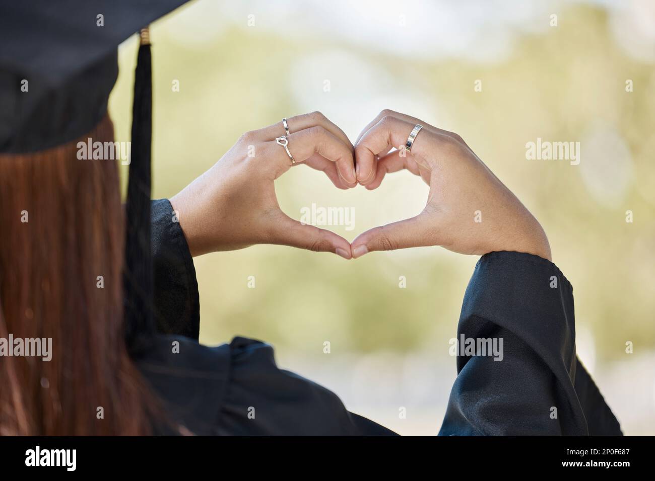 Student graduation, heart hand sign and education achievement outdoor ...