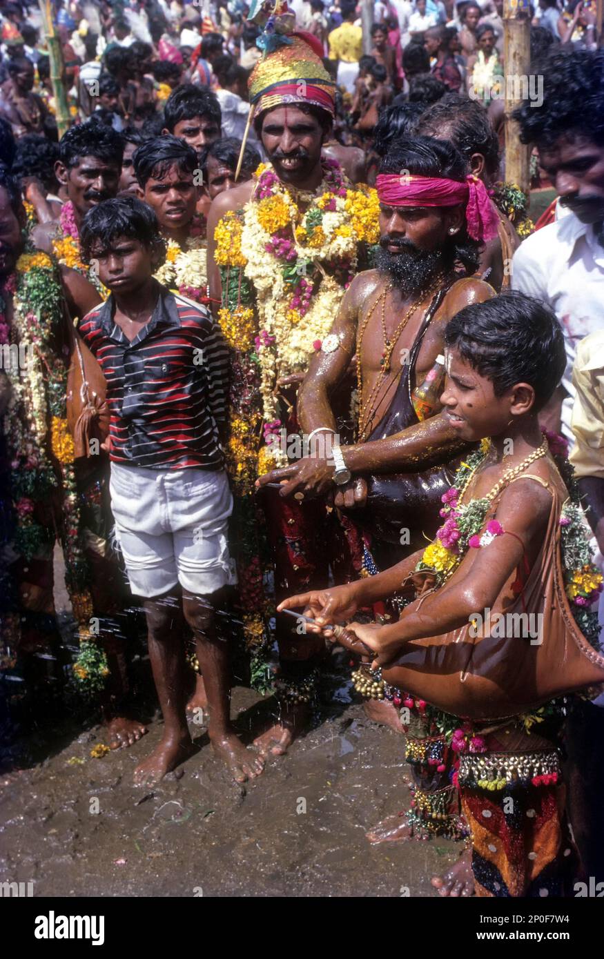 Devotees jetting water spray in Chitra or Chithirai festival, is one of ...
